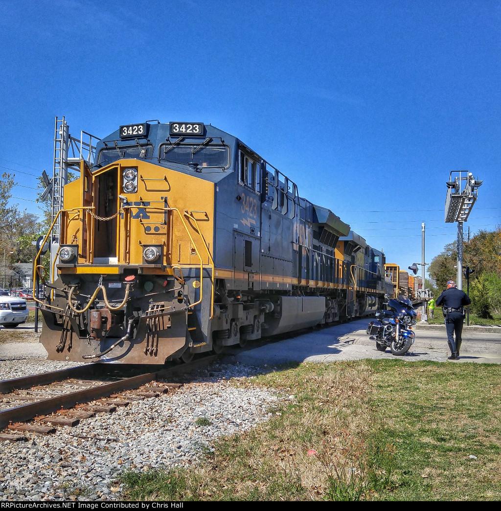 Parked car holds up train.